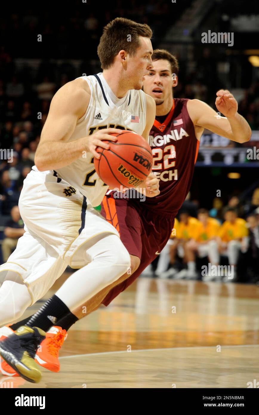 Notre Dame Pat Connaughton, left, drives the lane as Virginia Tech ...