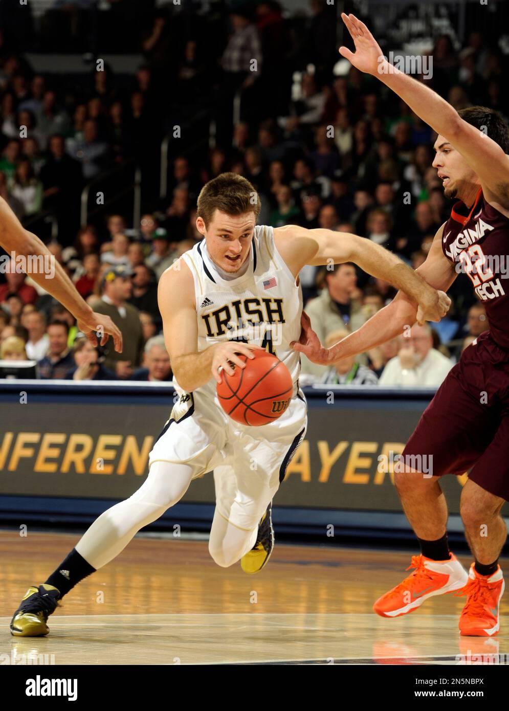 Notre Dame guard Pat Connaughton, left, drives the lane as Virginia ...