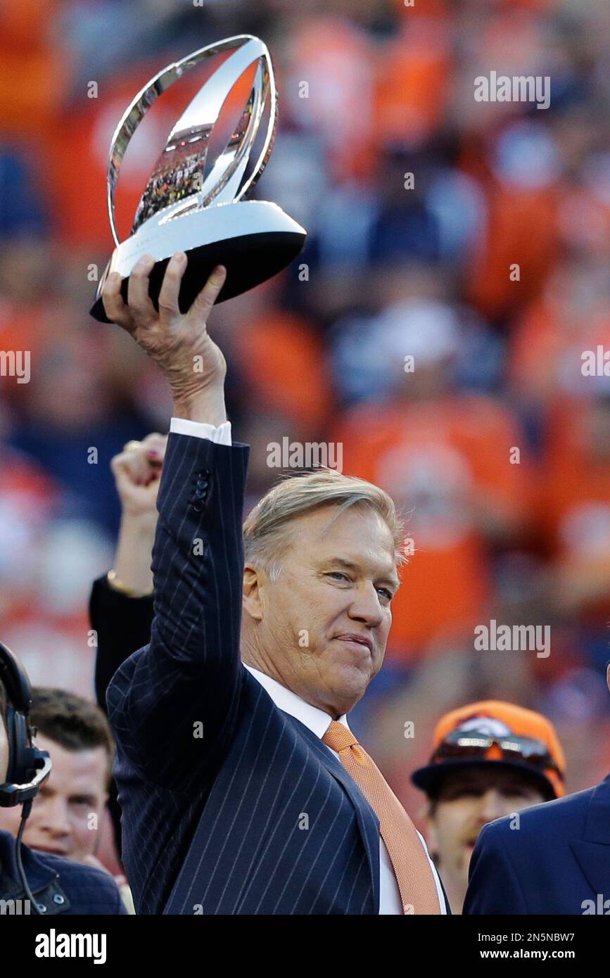 Denver Broncos Vice President John Elway holds up the trophy after the ...