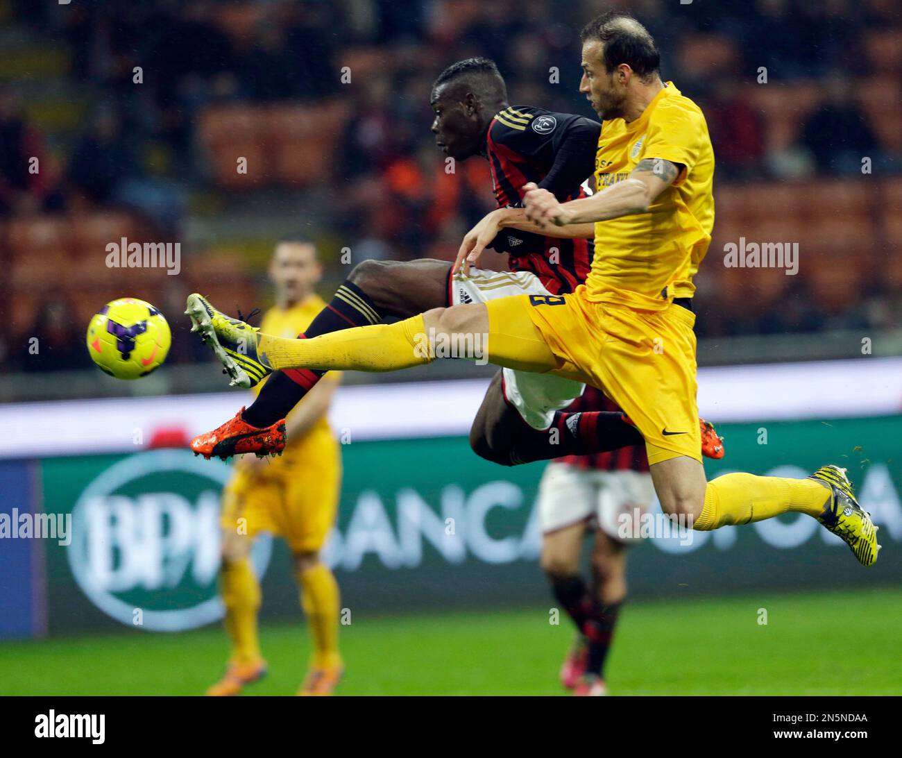 AC Milan forward Mario Balotelli, left, challenges for the ball with ...