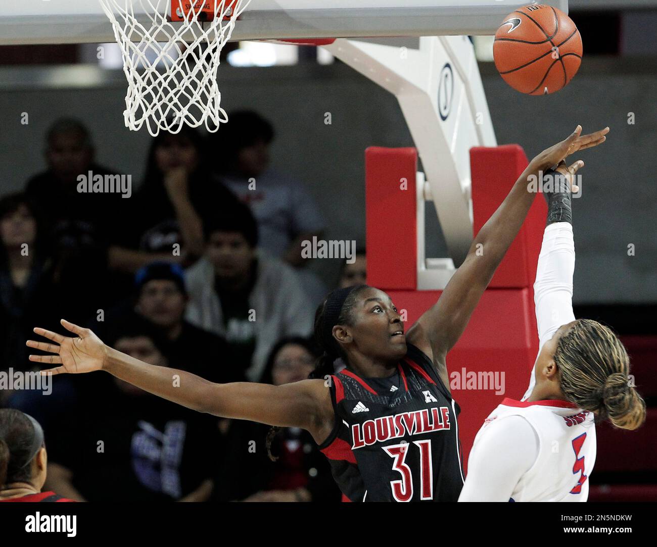 SMU forward Akil Simpson (5) attempts to shoot as Louisville's Asia ...
