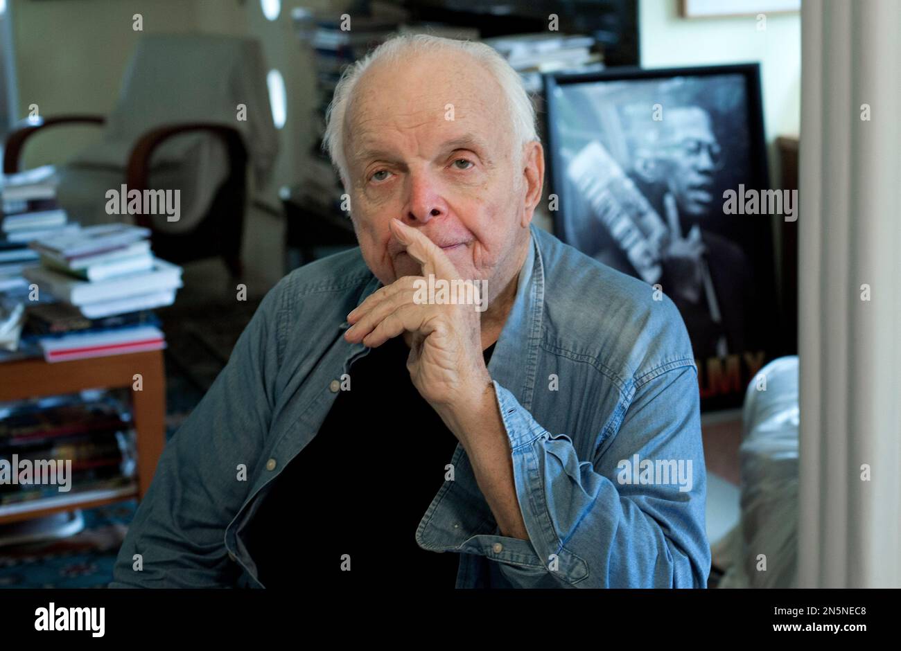 In this Jan. 9, 2014 photo, Bob Adelman sits in front of a photo of ...