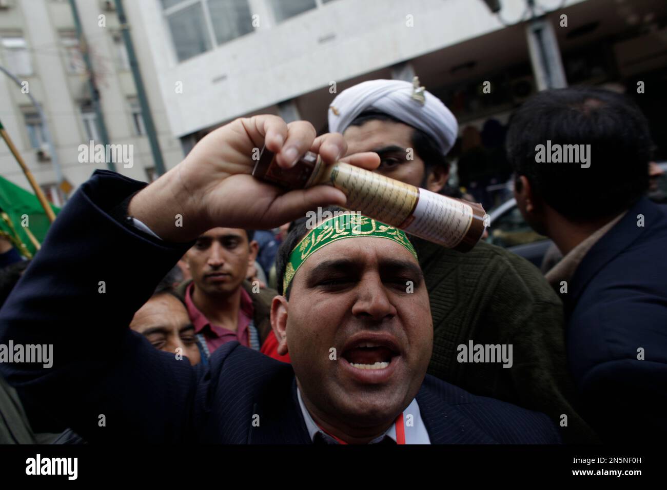 A Muslim immigrant chants religious slogans in a procession of devotees ...