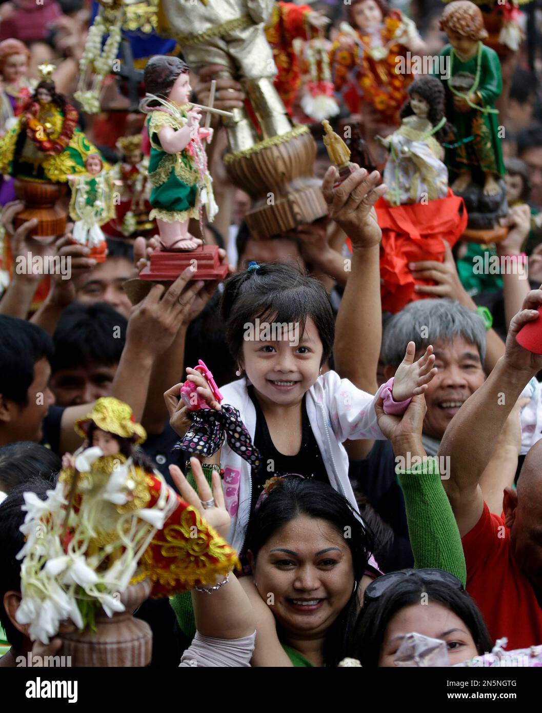 A child is raised along with images of the Infant Jesus known as Sto ...