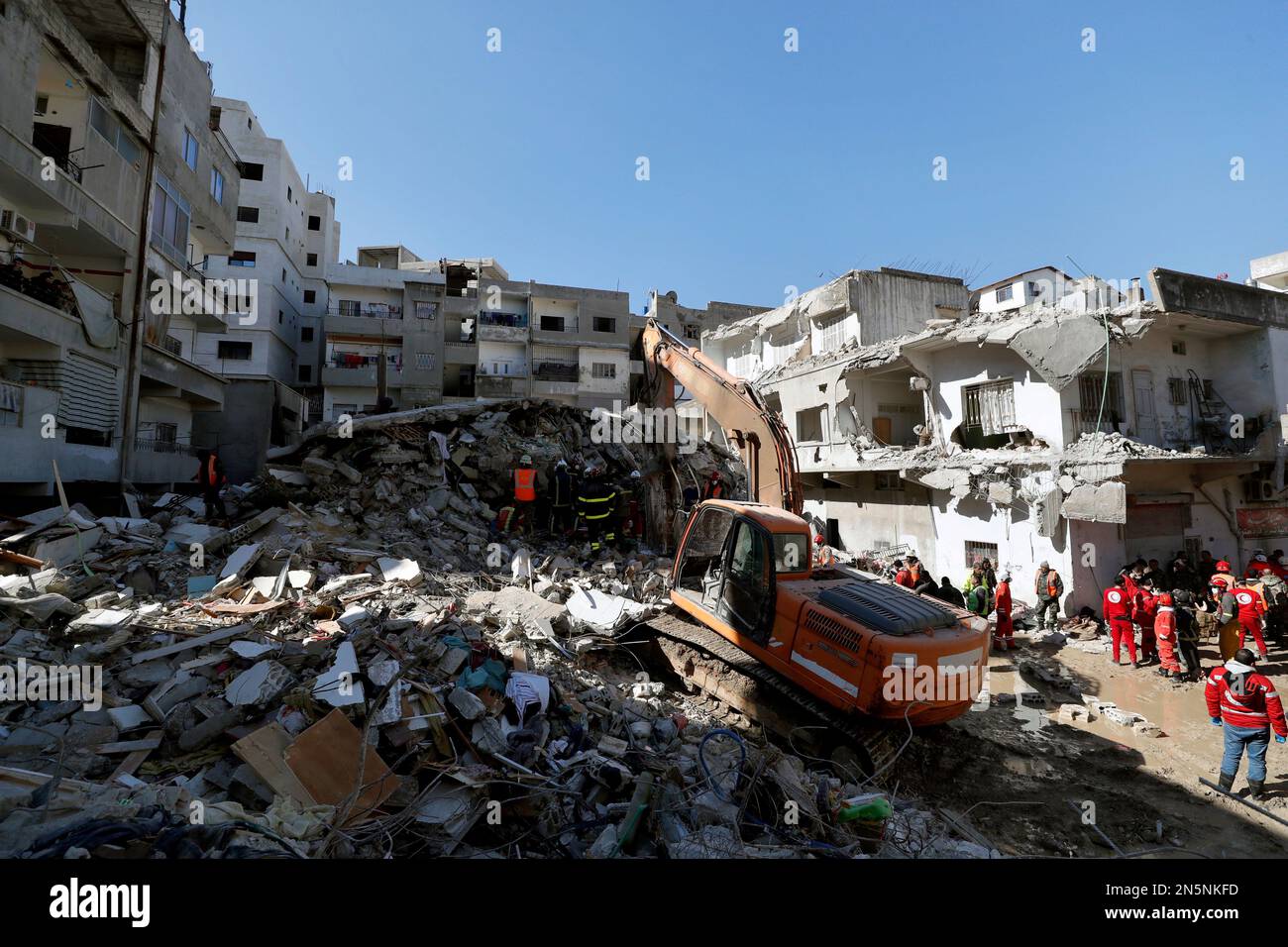 Rescue workers search for survivor on a collapsed building in the ...
