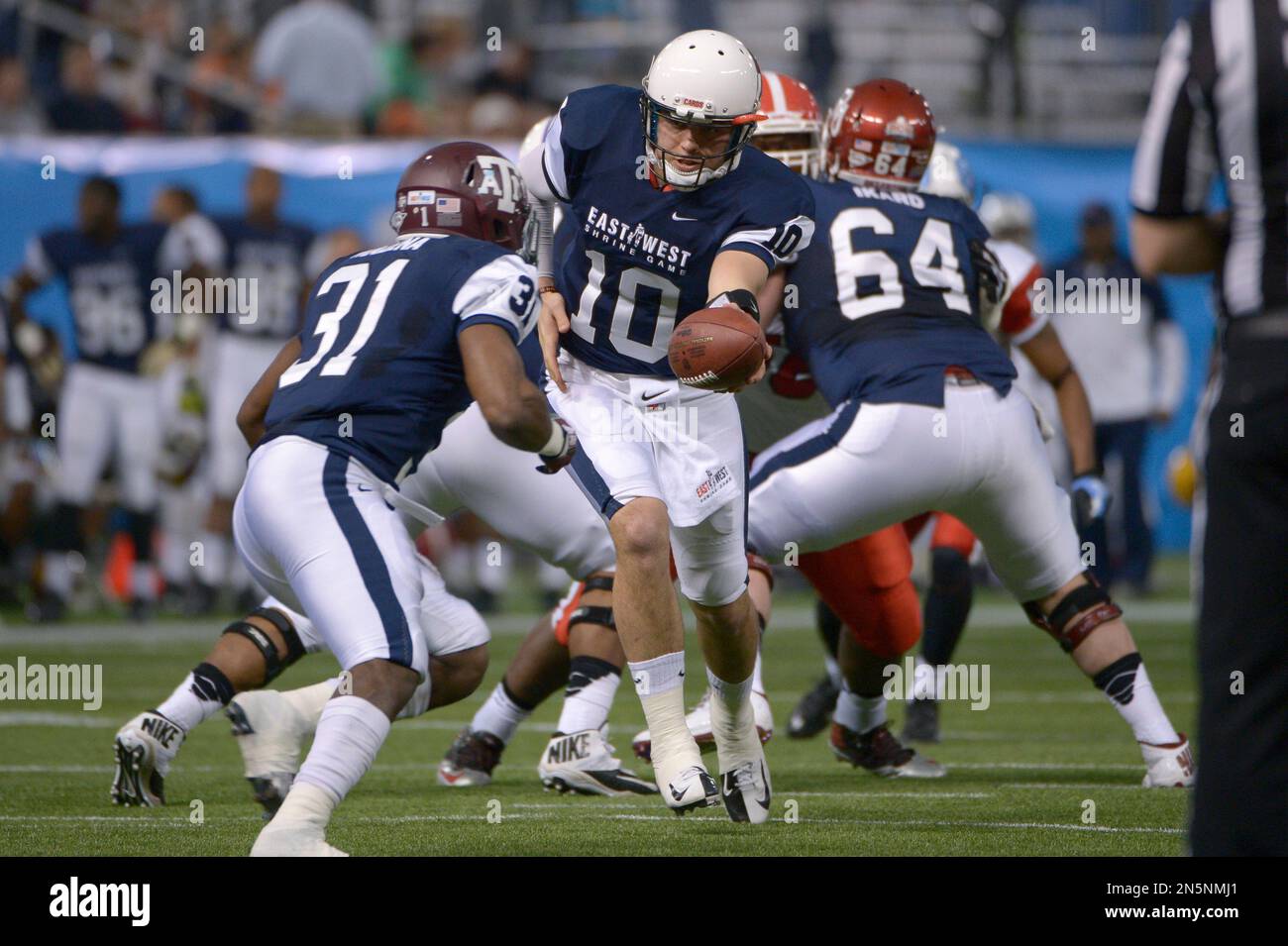 West quarterback Keith Wenning (10), of Ball State, hands the ball off ...