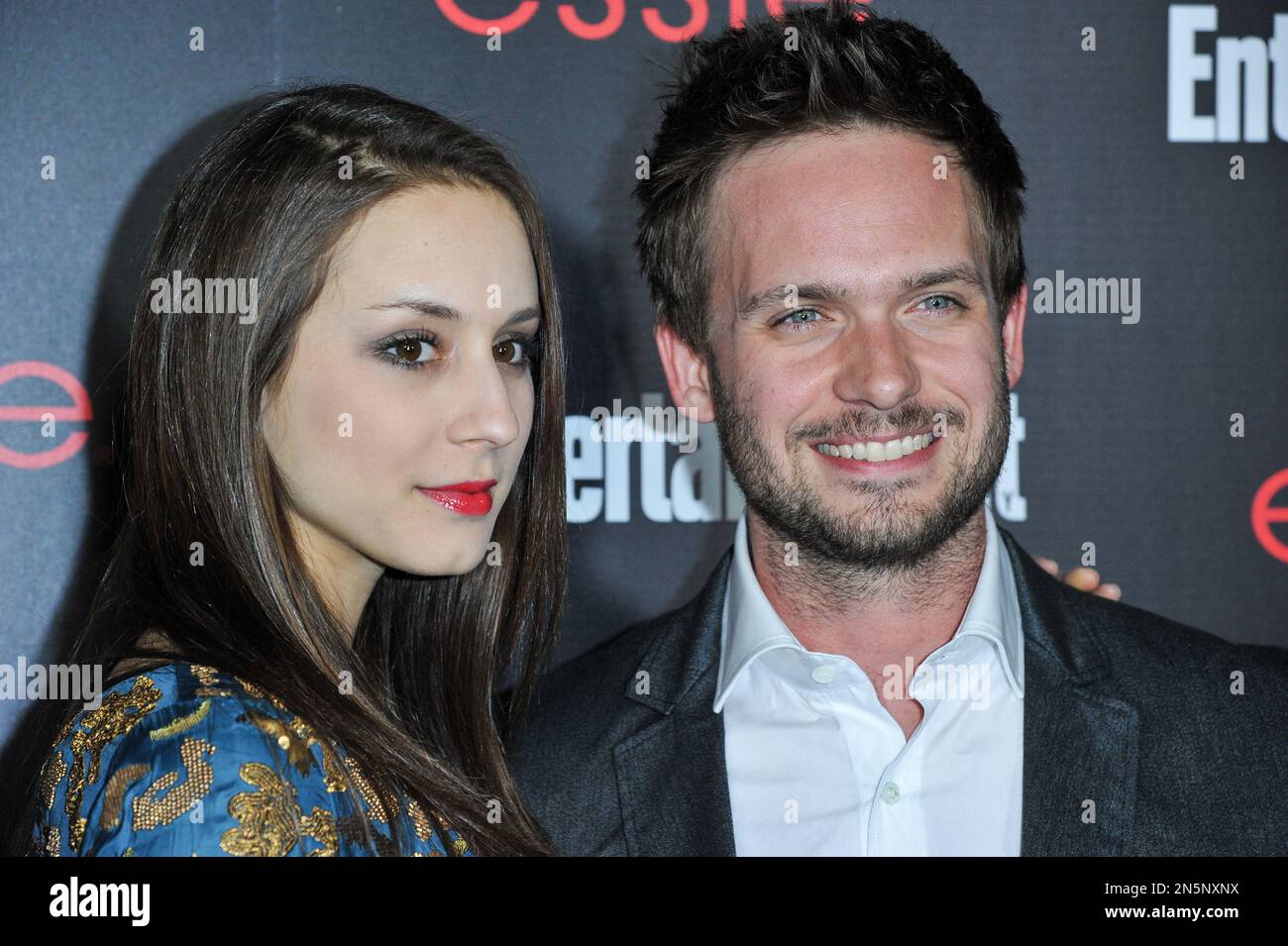 Troian Bellisario, left, and Patrick J. Adams arrive at the ...