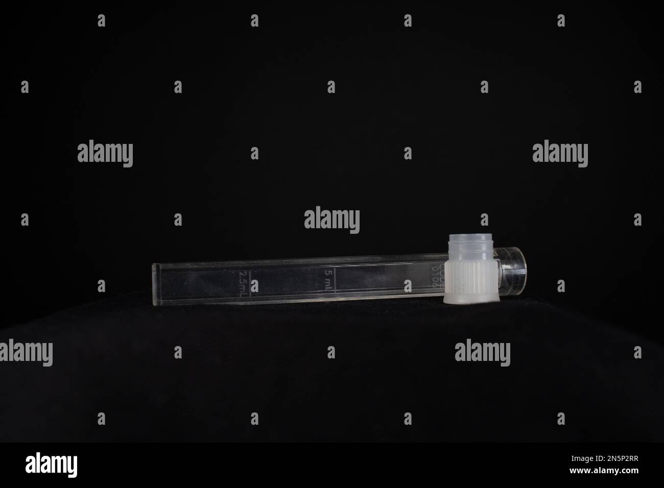 clear plastic phosphate measuring flask with white plastic lid off ...