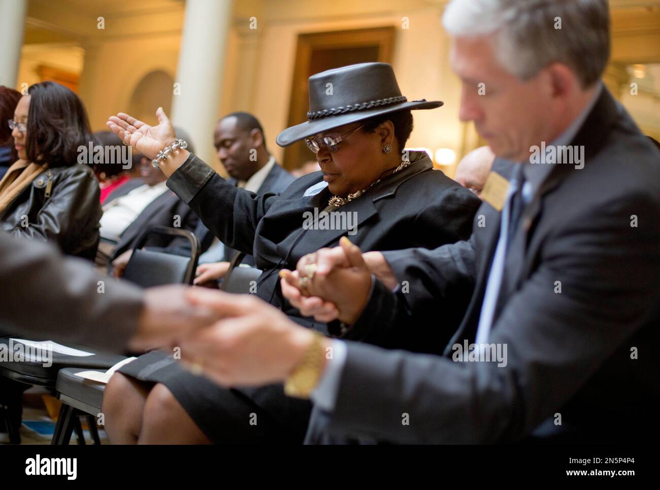 Georgia Rep. Sharon Beasley-Teague, D-Red Oak, center, joins hand with ...