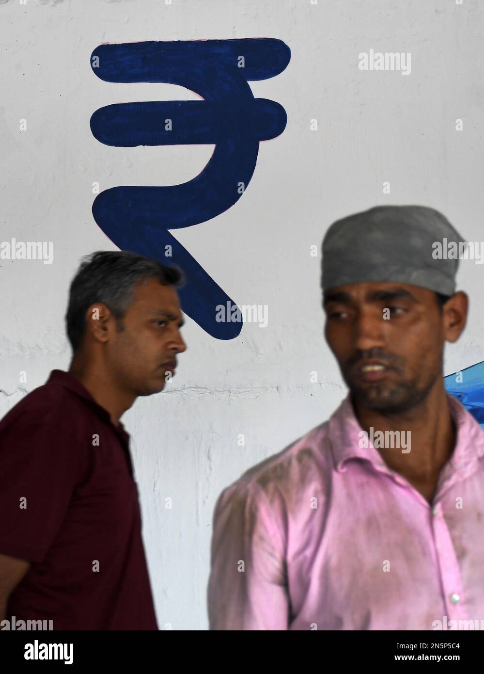 People walk past a graffiti of Bombay Stock Exchange (BSE) in Mumbai ...
