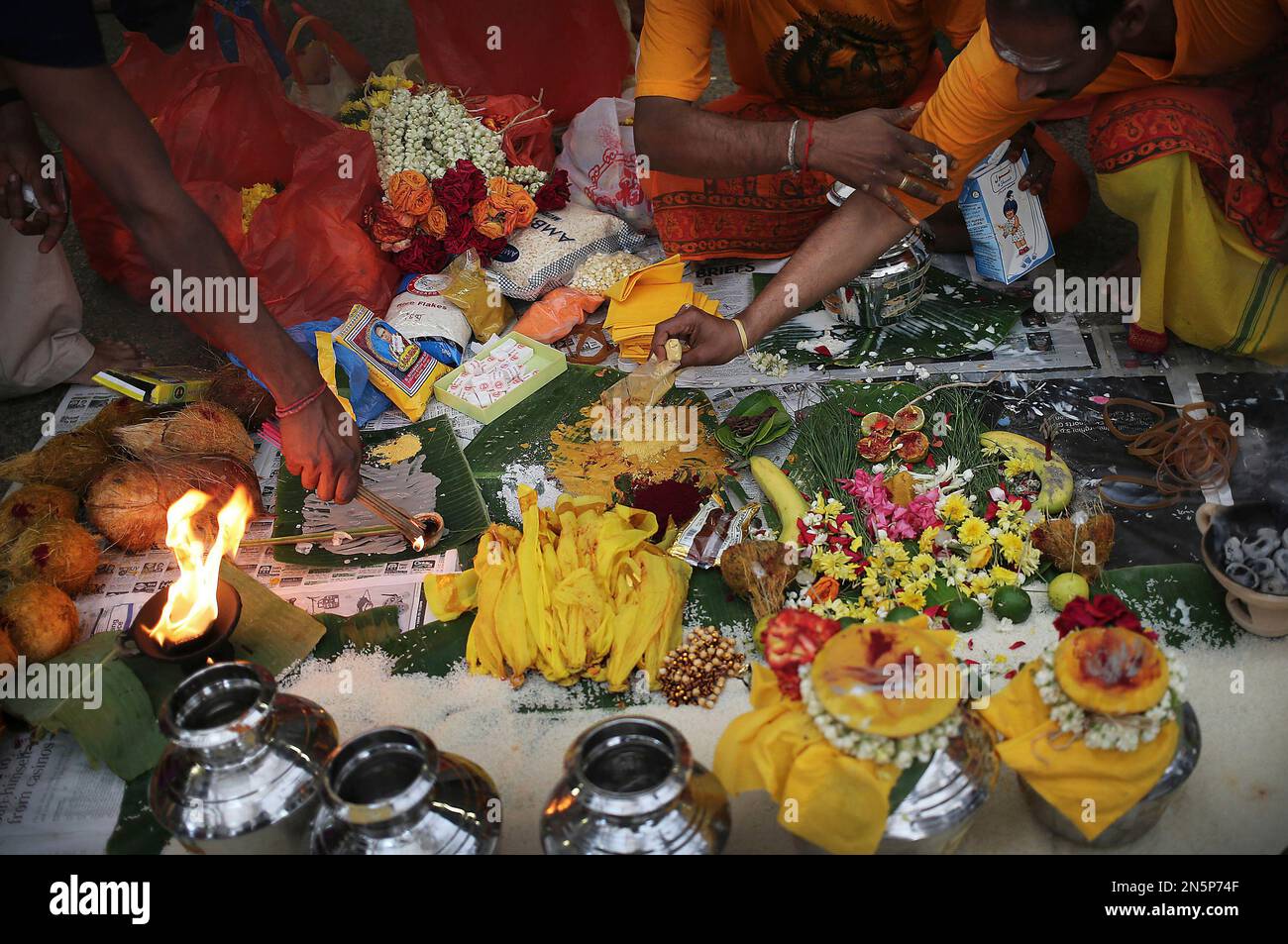 Hindu devotees make offerings, Friday, Jan. 17, 2014 at the Sri ...