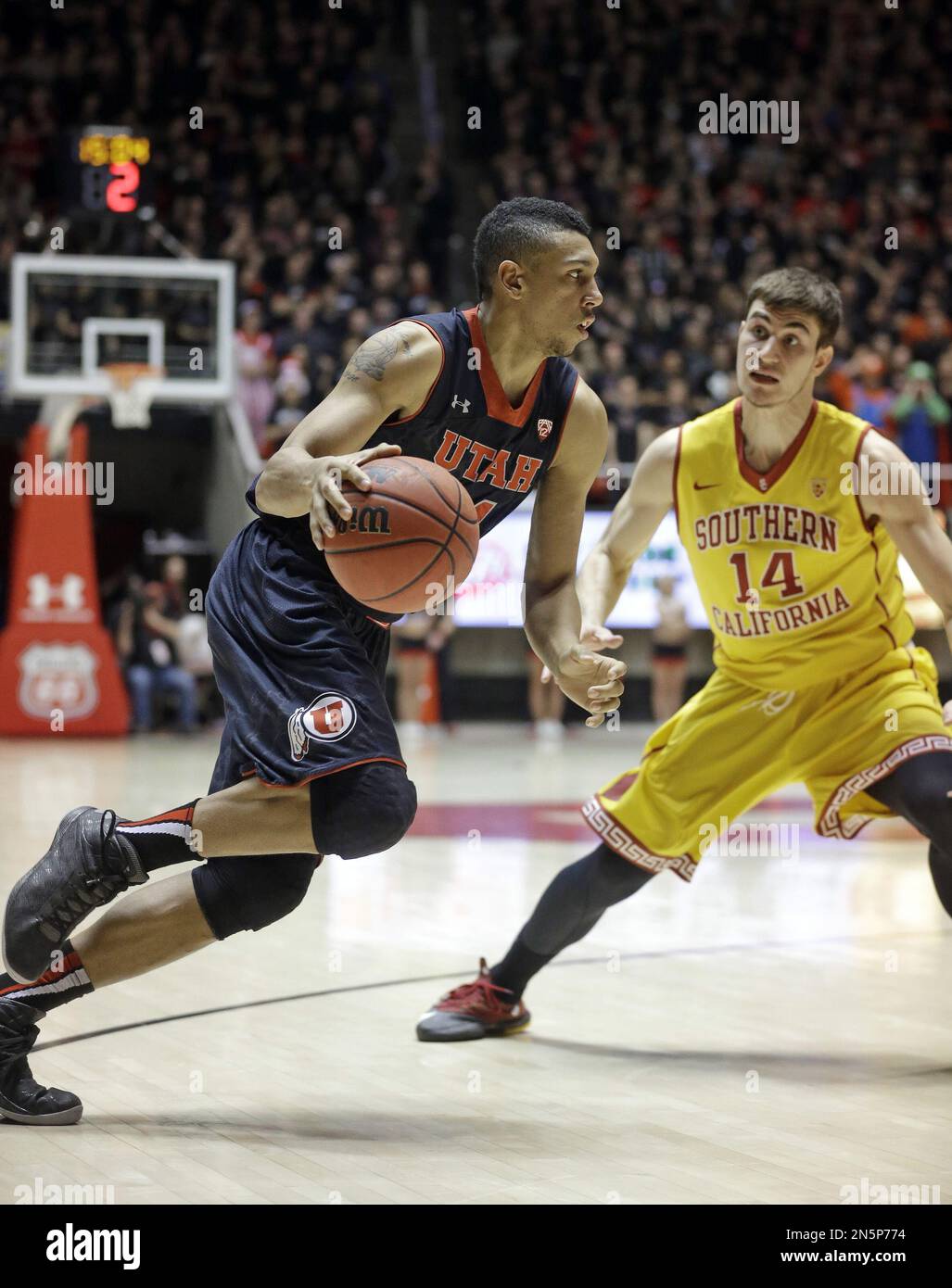 Utah's Jordan Loveridge (21) drives around Southern California's ...