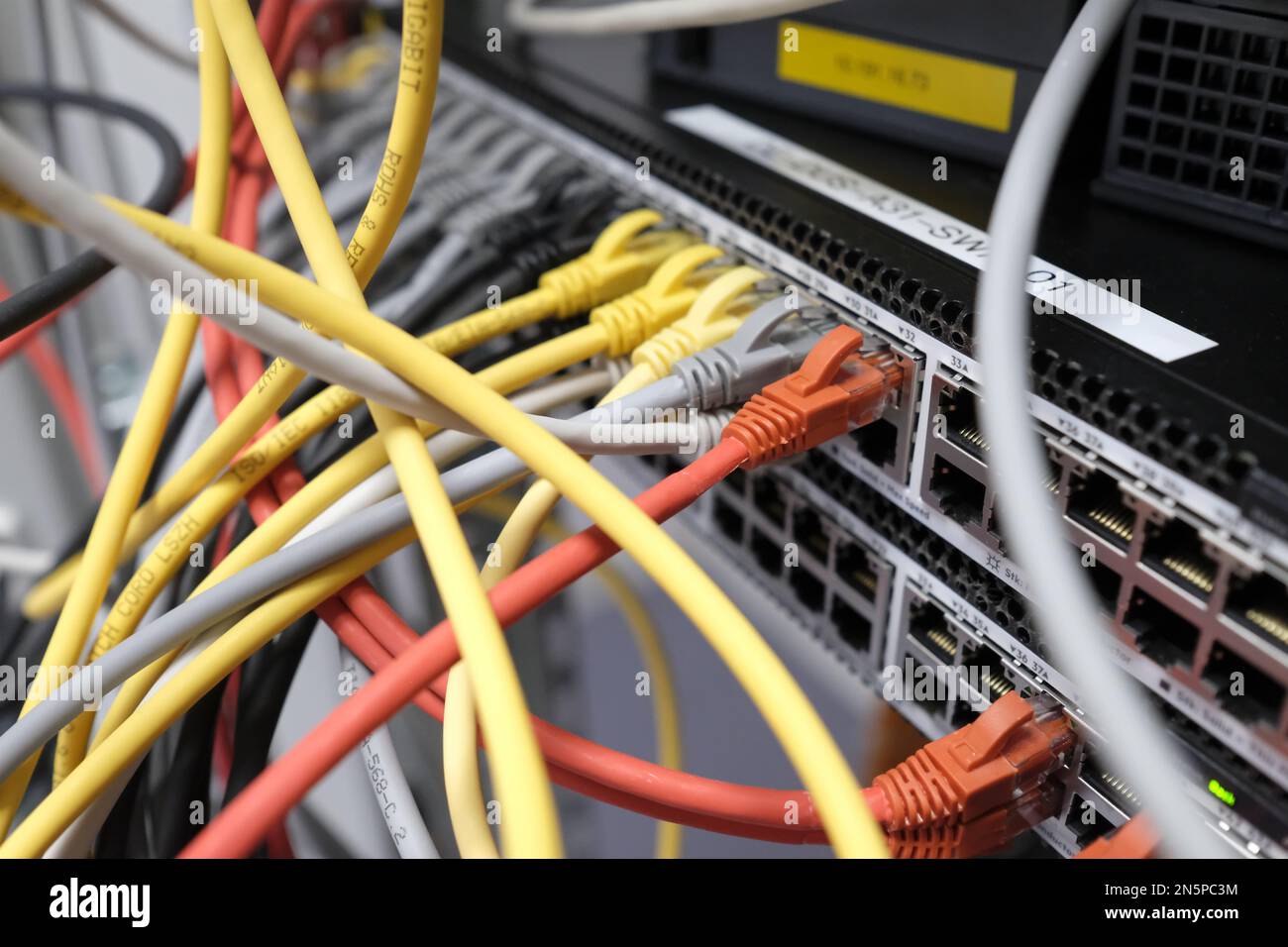 Network technology - multiple colorful cables in an IT and server room ...