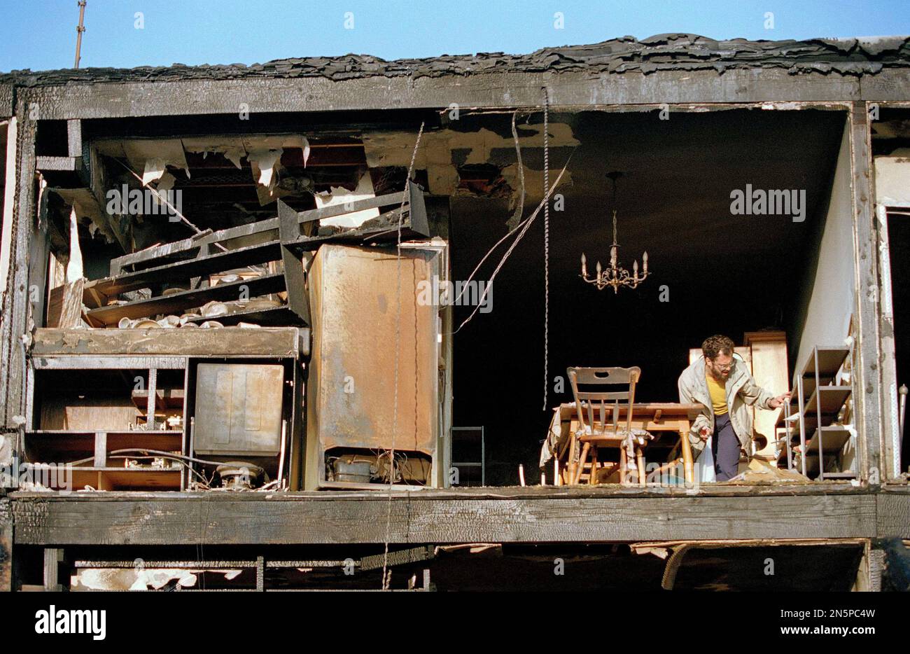 John Rimer of Lawrence, Ga., goes through the rubble of his sister's ...