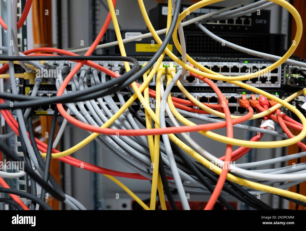 Network technology - multiple colorful cables in an IT and server room ...
