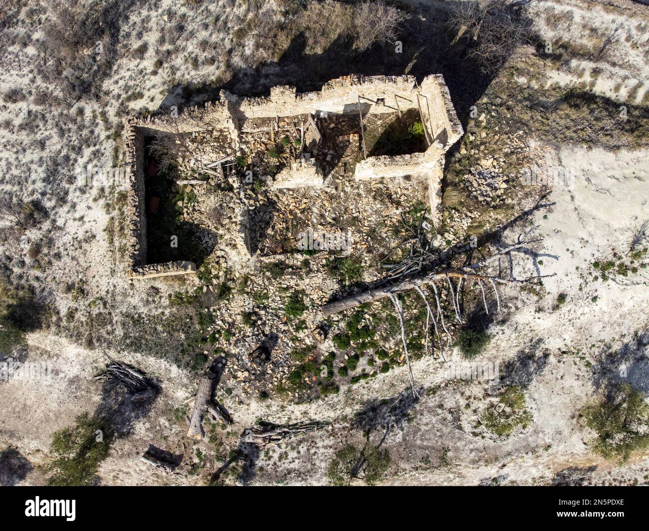 aerial view of farm house in ruins in olive grove near the village of ...