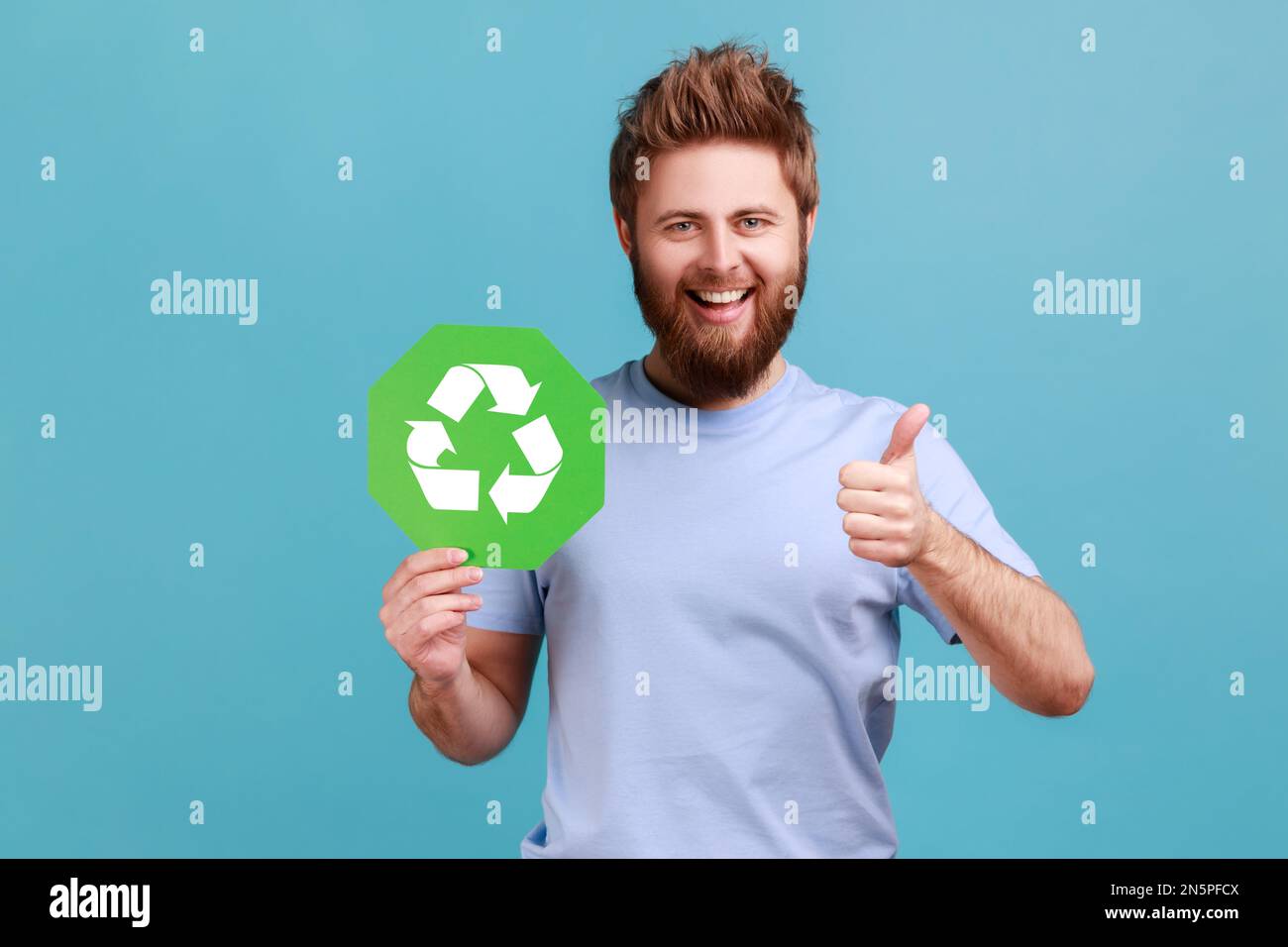 Portrait of positive smiling bearded man showing thumbs up gesture ...