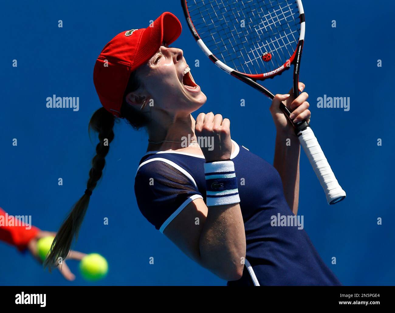 Alize Cornet of France celebrates after winning her second round match ...