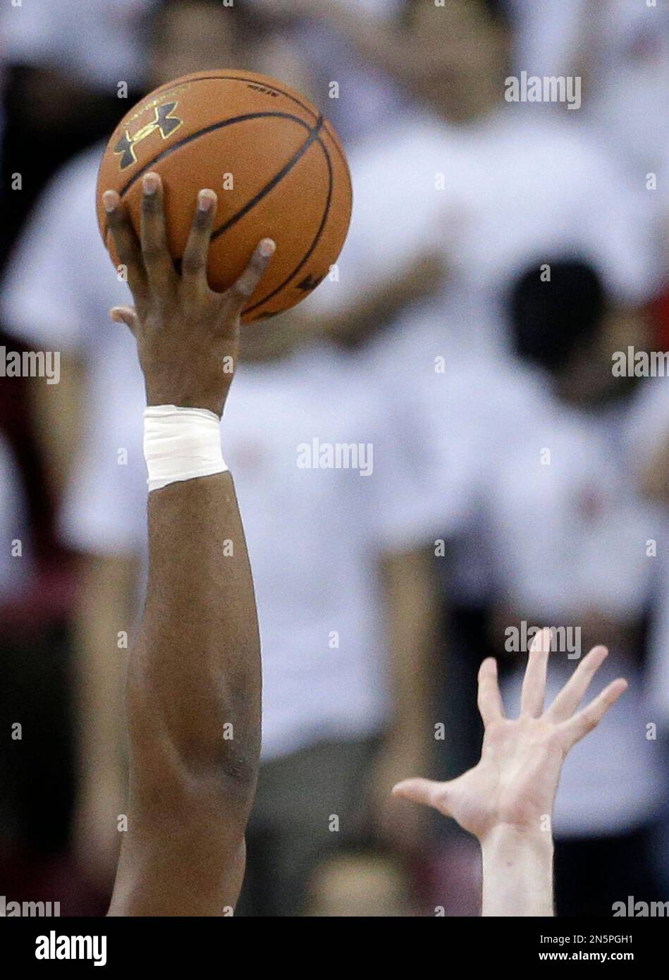 Maryland center Shaquille Cleare, left, of the Bahamas, shoots over ...