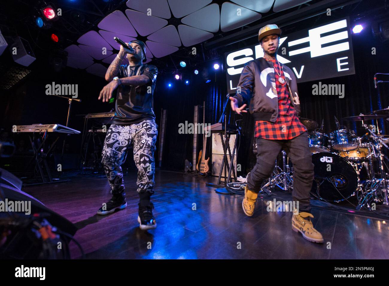 Rapper Kid Ink (L) and Tyga perform on stage during filming of SKEE ...