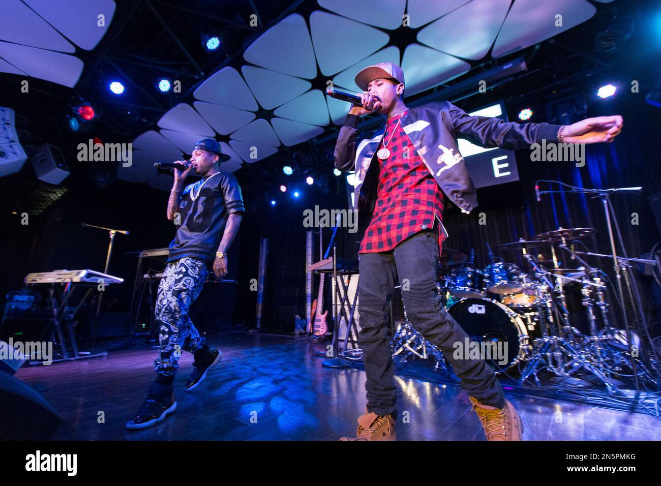 Rapper Kid Ink (L) and Tyga perform on stage during filming of SKEE ...