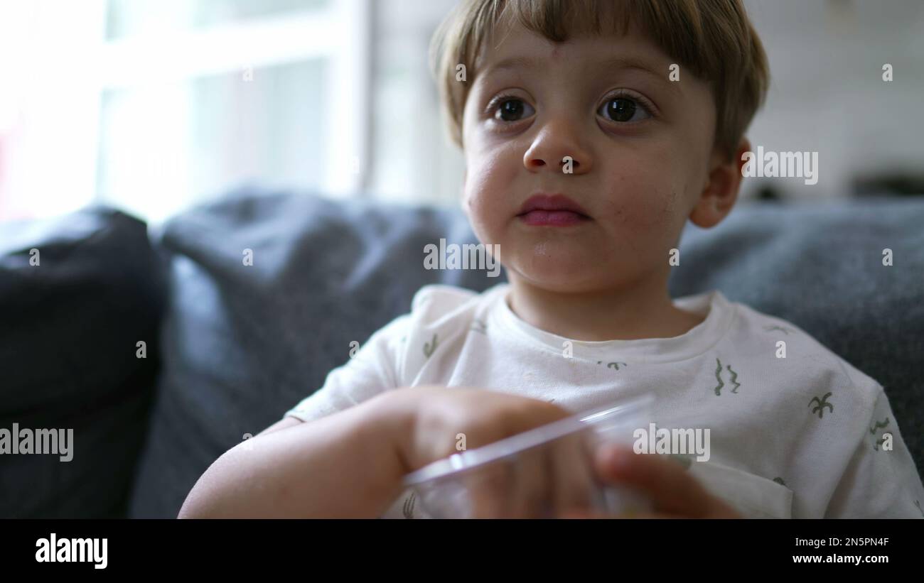Child eating blueberries. Little boy snacking healthy blueberry fruit ...