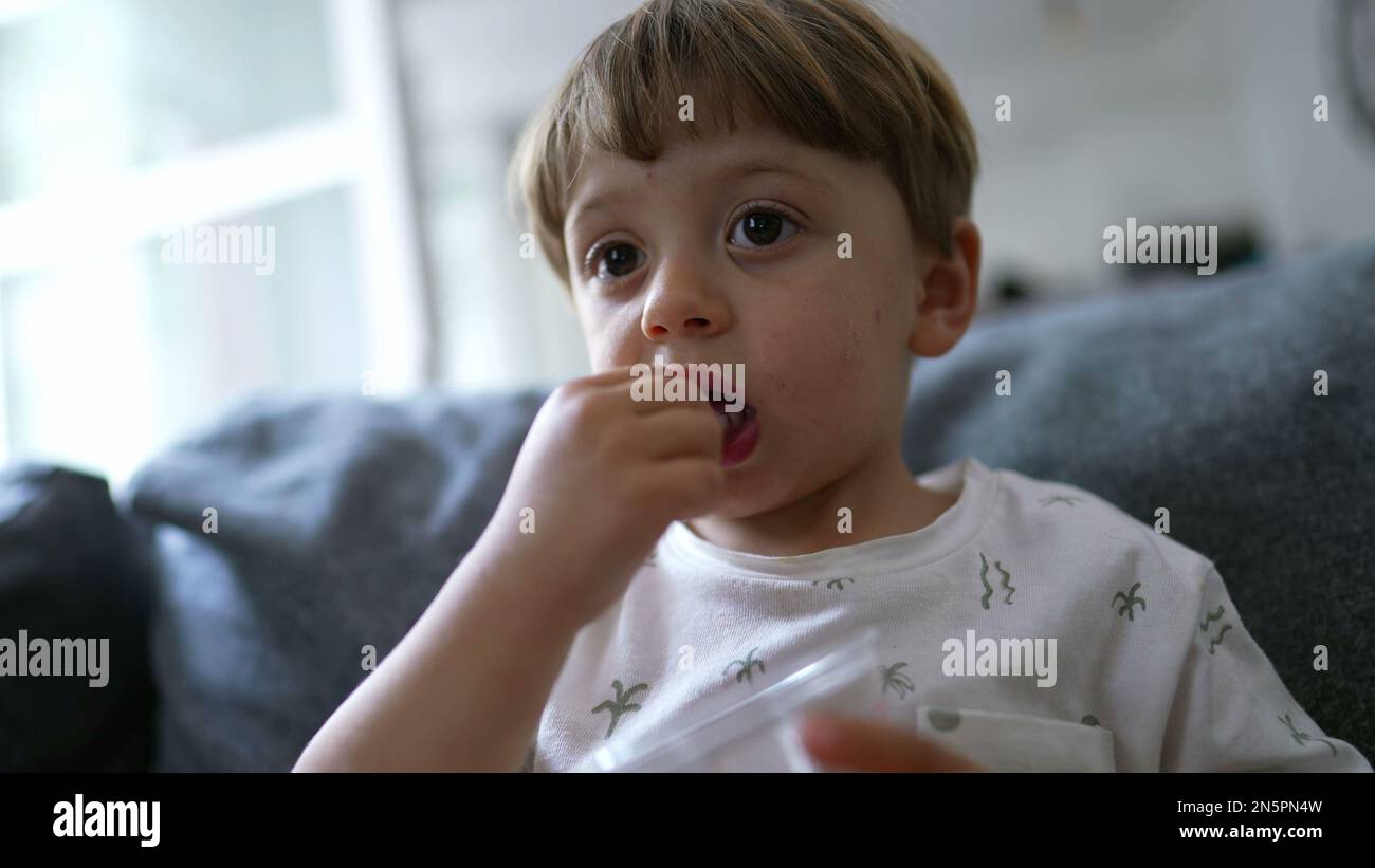 Child eating blueberries. Little boy snacking healthy blueberry fruit ...