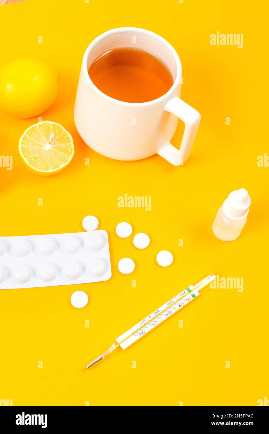 Medicines for treatment- pills, spray bottles, thermometer, Lemon ...