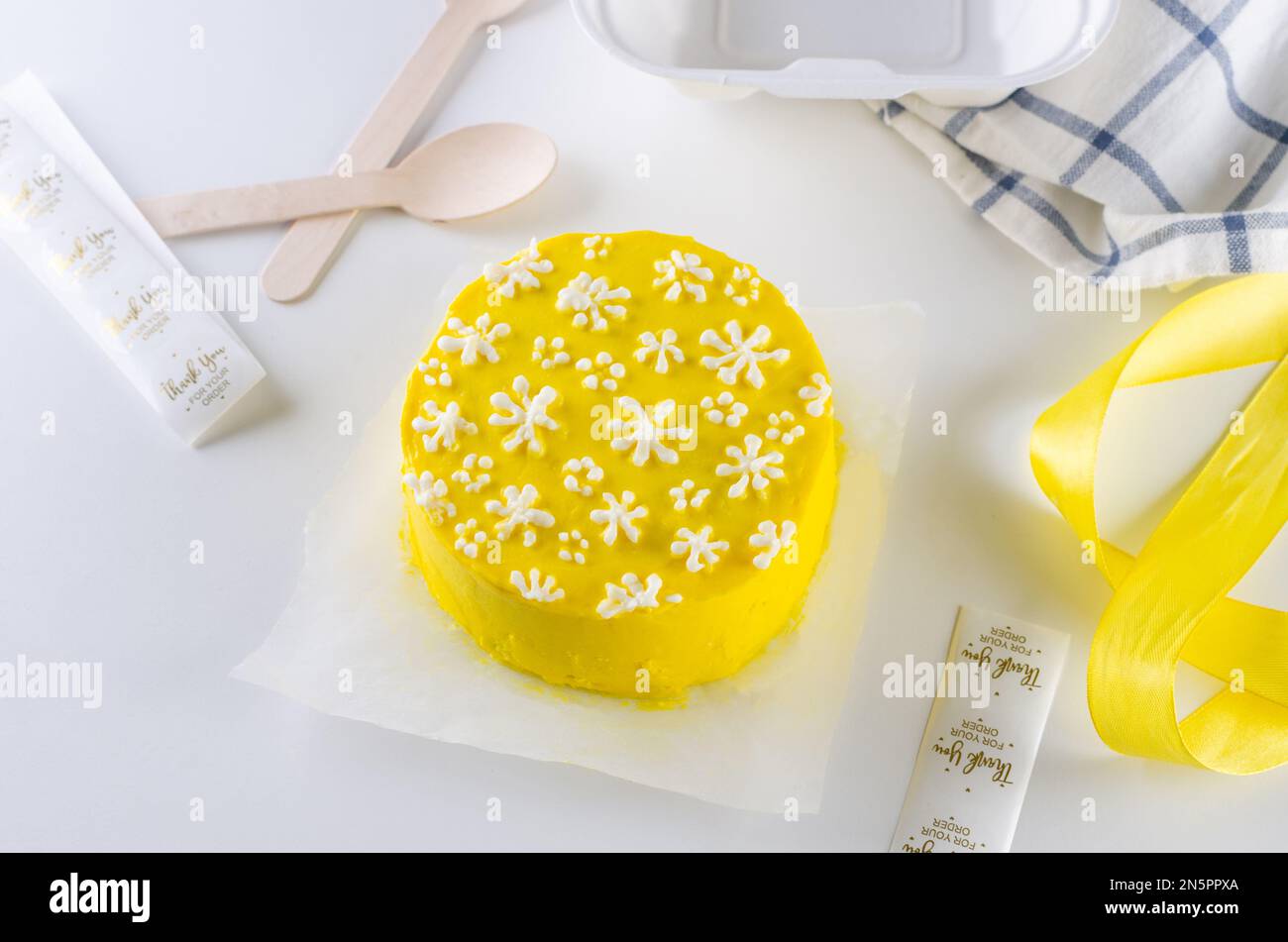 Trendy bento cake yellow color with cute decor on light background ...