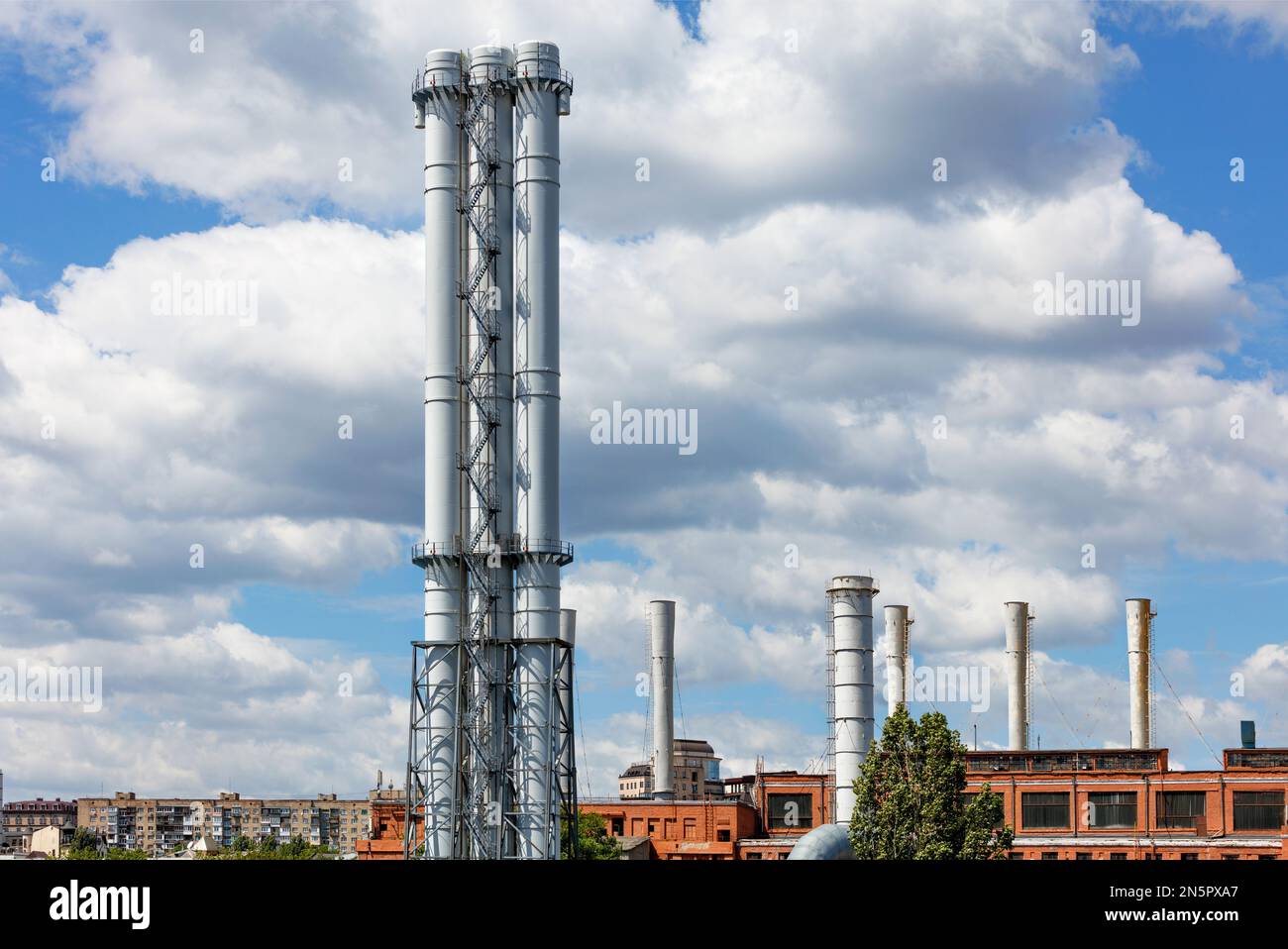 The tall triple stacks of the city's thermal power plant rise above ...