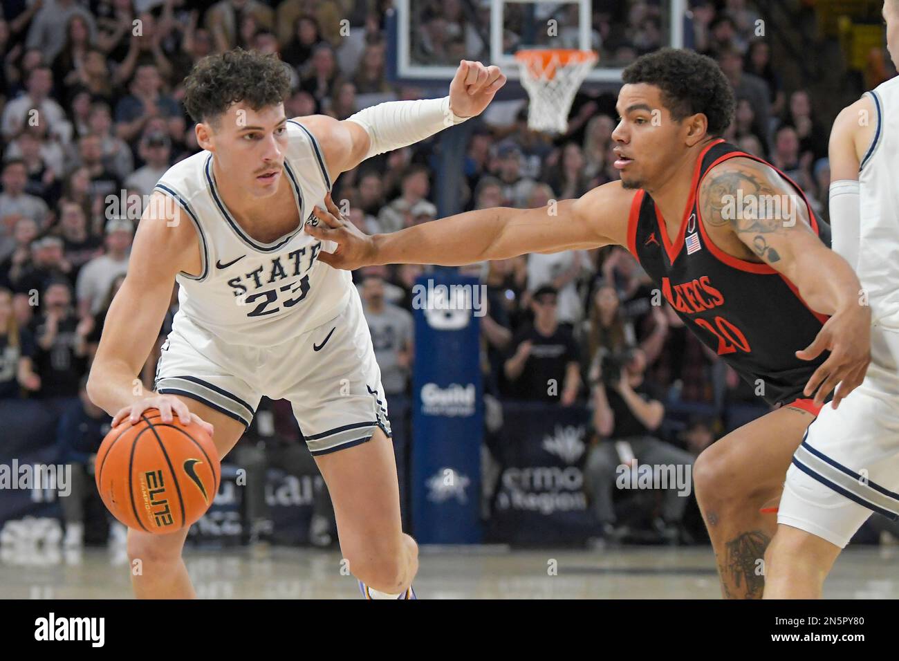 Utah State forward Taylor Funk (23) dribbles the ball as San Diego ...