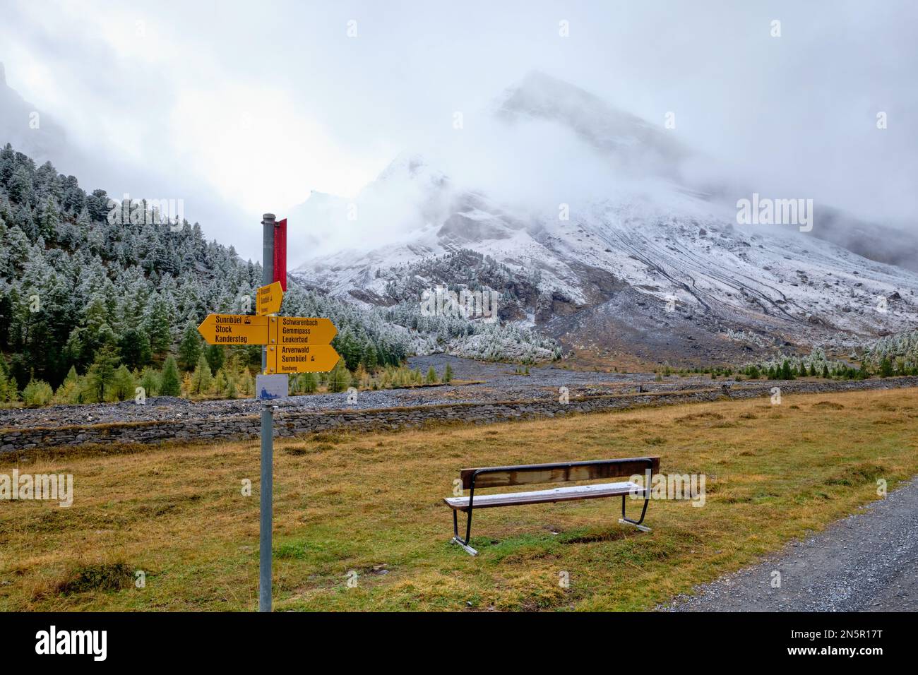 A bench to rest and distinctive yellow direction signs. Gemmi Pass ...