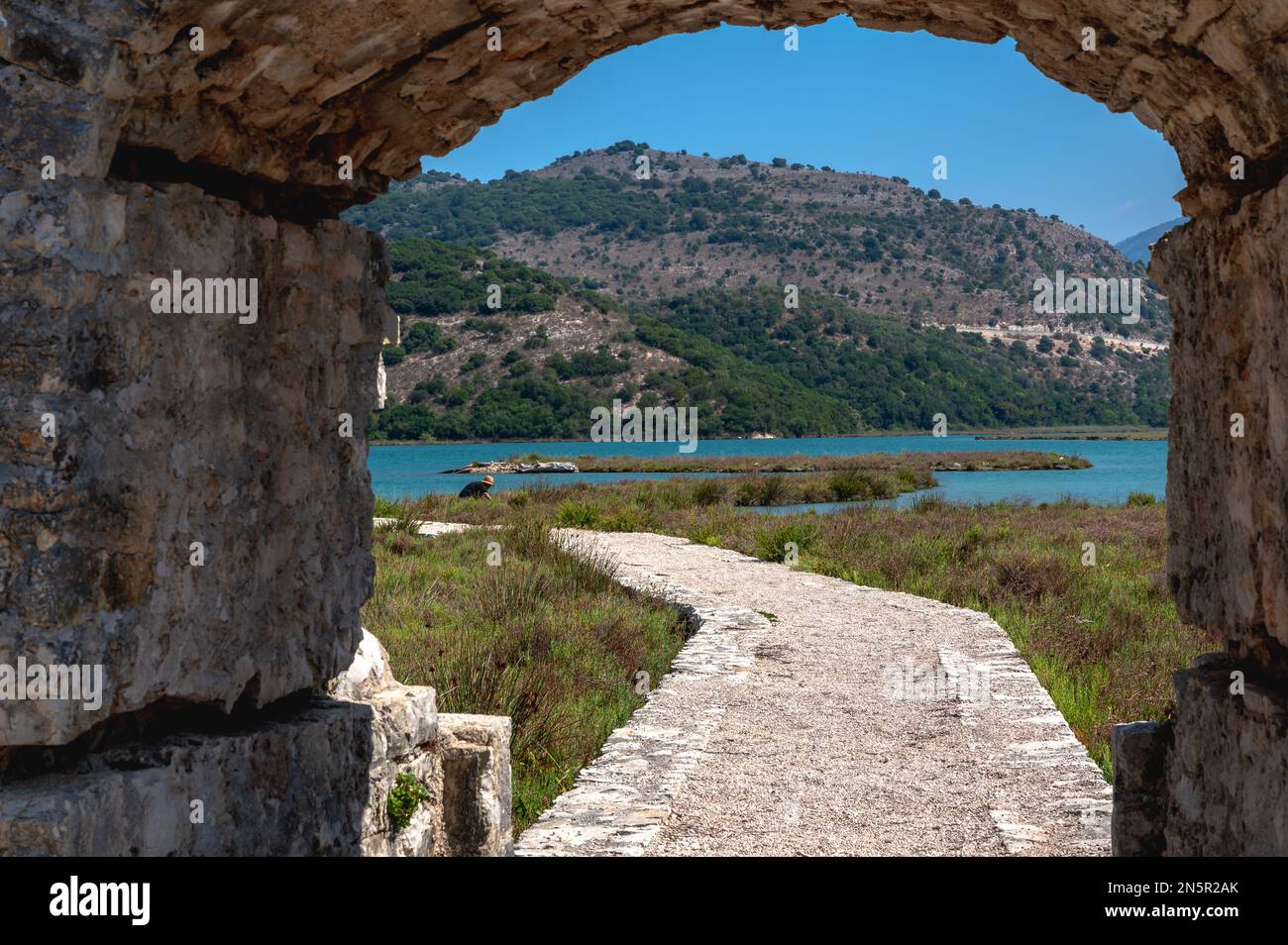 A view from Ali Pasha Castle arch gate by lake Butrint with green ...