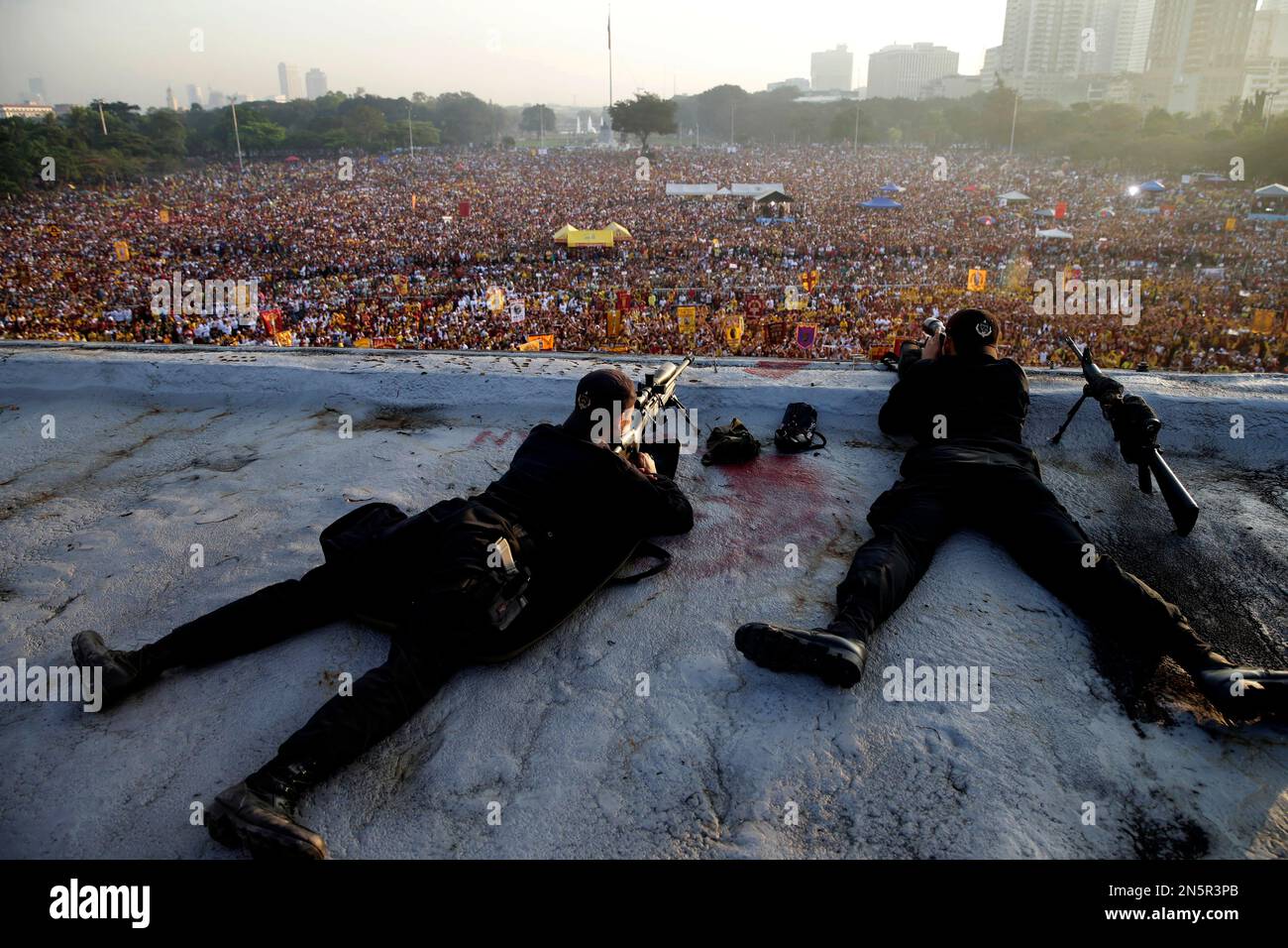 Police snipers keep watch at thousands of devotees who gathered at ...