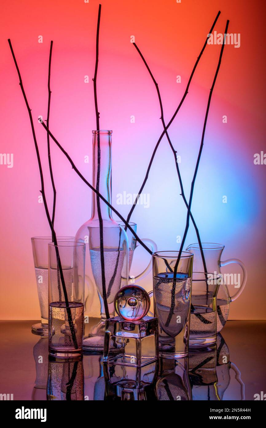 Still life with glassware with liquid and sticks Stock Photo - Alamy