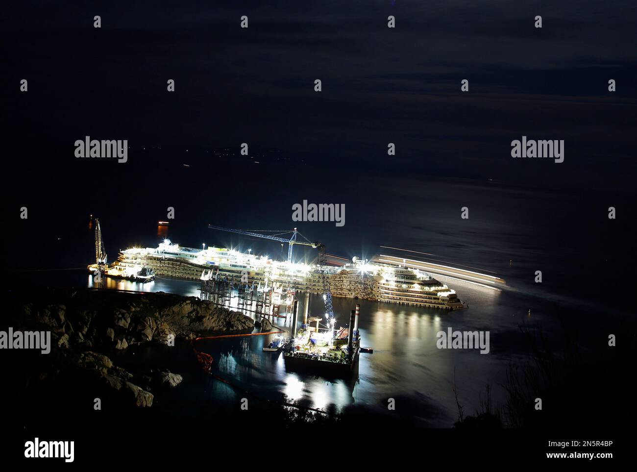 In this photo taken with a slow shutter speed, lights illuminate the ...