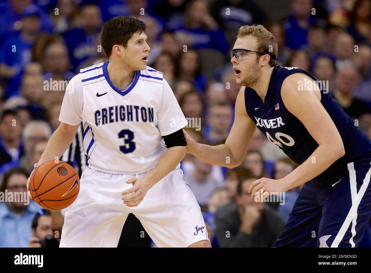 Creighton's Doug McDermott (3) is guarded by Xavier's Matt Stainbrook ...