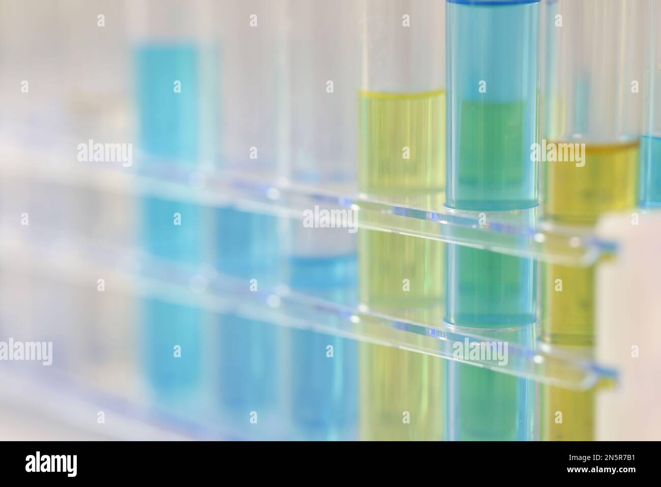 Many test tubes with different chemical solutions in a row on ...