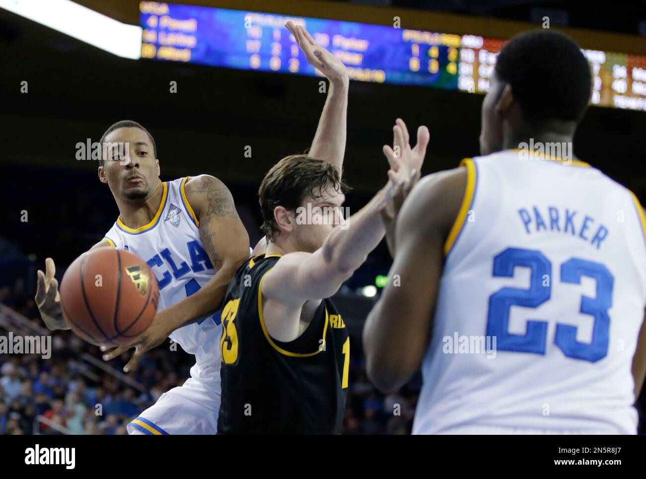 UCLA guard Norman Powell, left, passes around Arizona State center ...