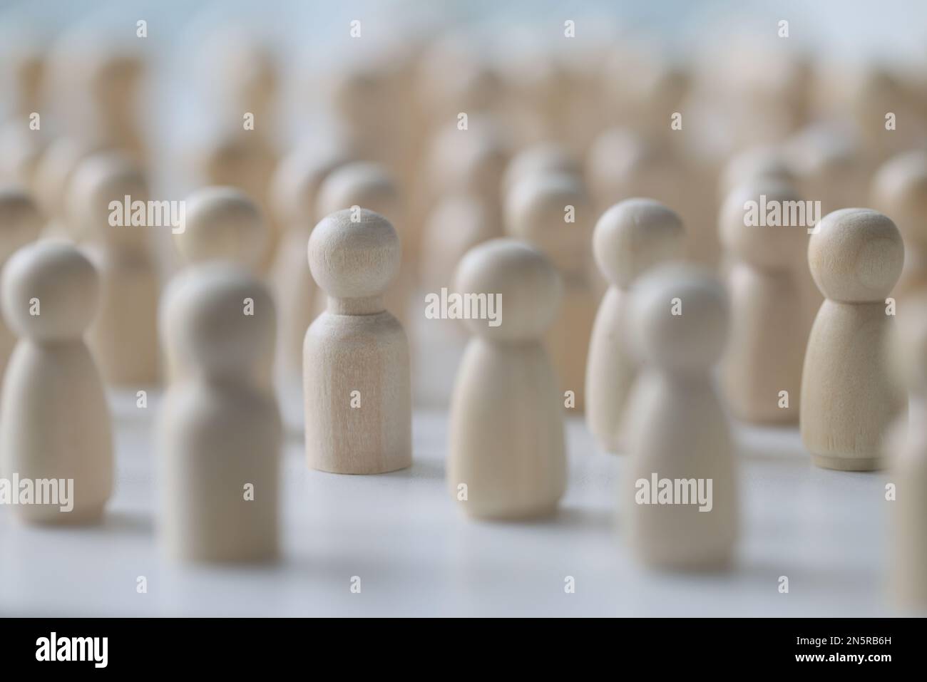 Many wooden figures standing close to each other, shallow depth of ...