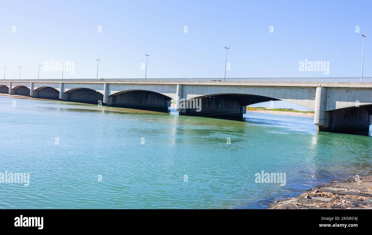 River estuary mouth water flowing out into blue ocean sea along beach ...