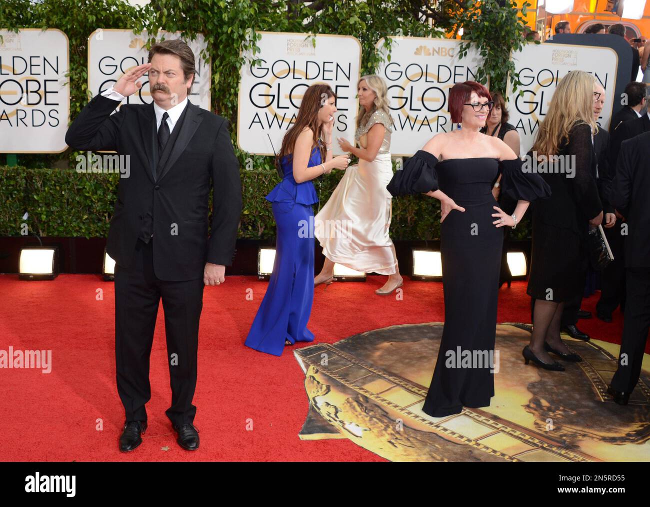 Nick Offerman, left, salutes the crowd as his wife Megan Mullally poses ...