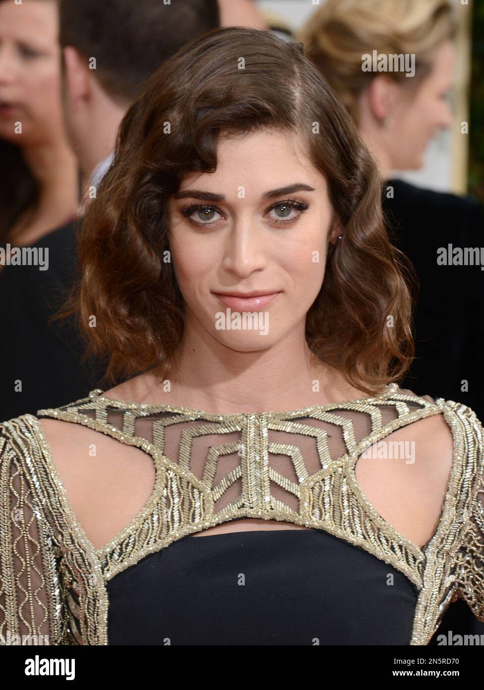 Lizzy Caplan arrives at the 71st annual Golden Globe Awards at the ...
