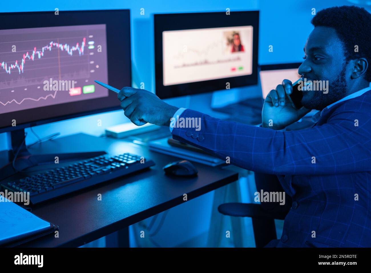 Businessman using graphs and all the technological resources to make ...