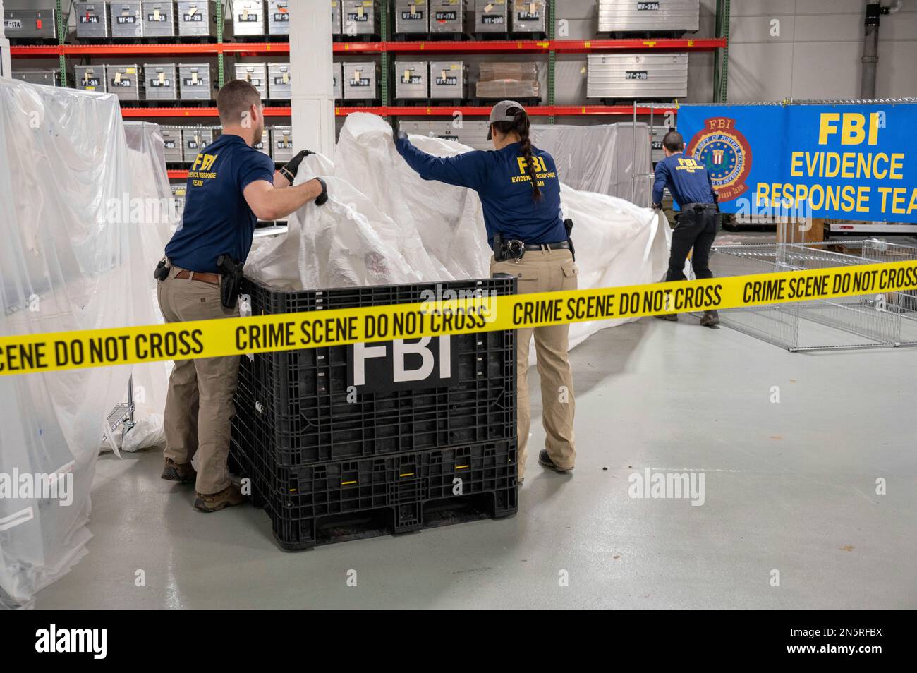 In this image provided by the FBI, FBI special agents assigned to the evidence response team ...