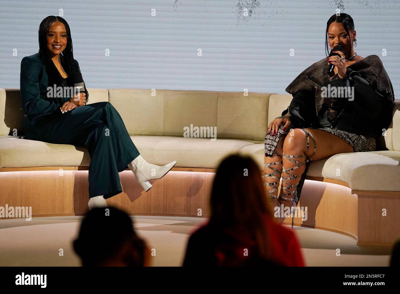 Apple Music's Nadeska Alexis, left, speaks with Rihanna during a ...