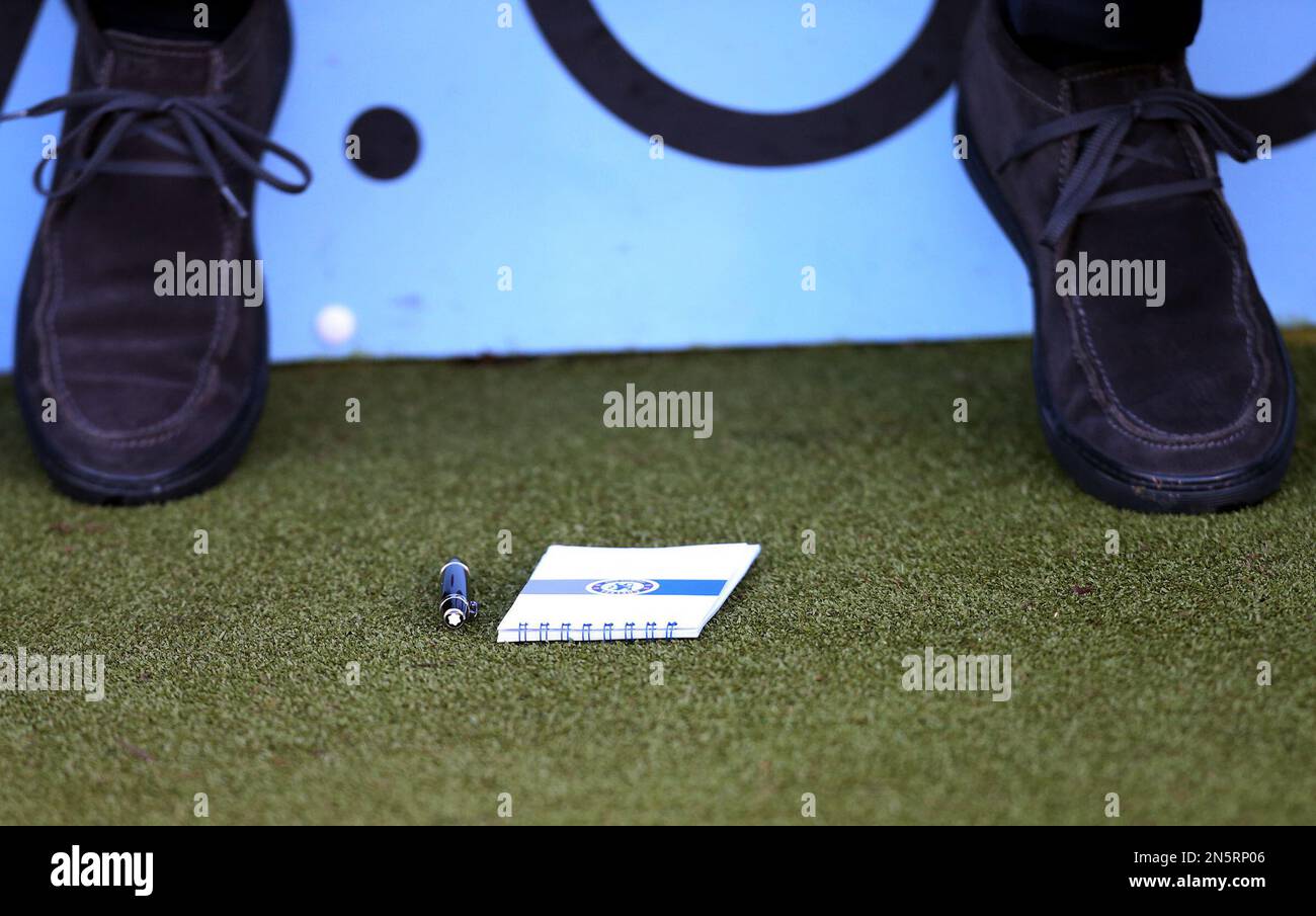 Chelsea's manager Jose Mourinho has placed his notepad and pen between ...