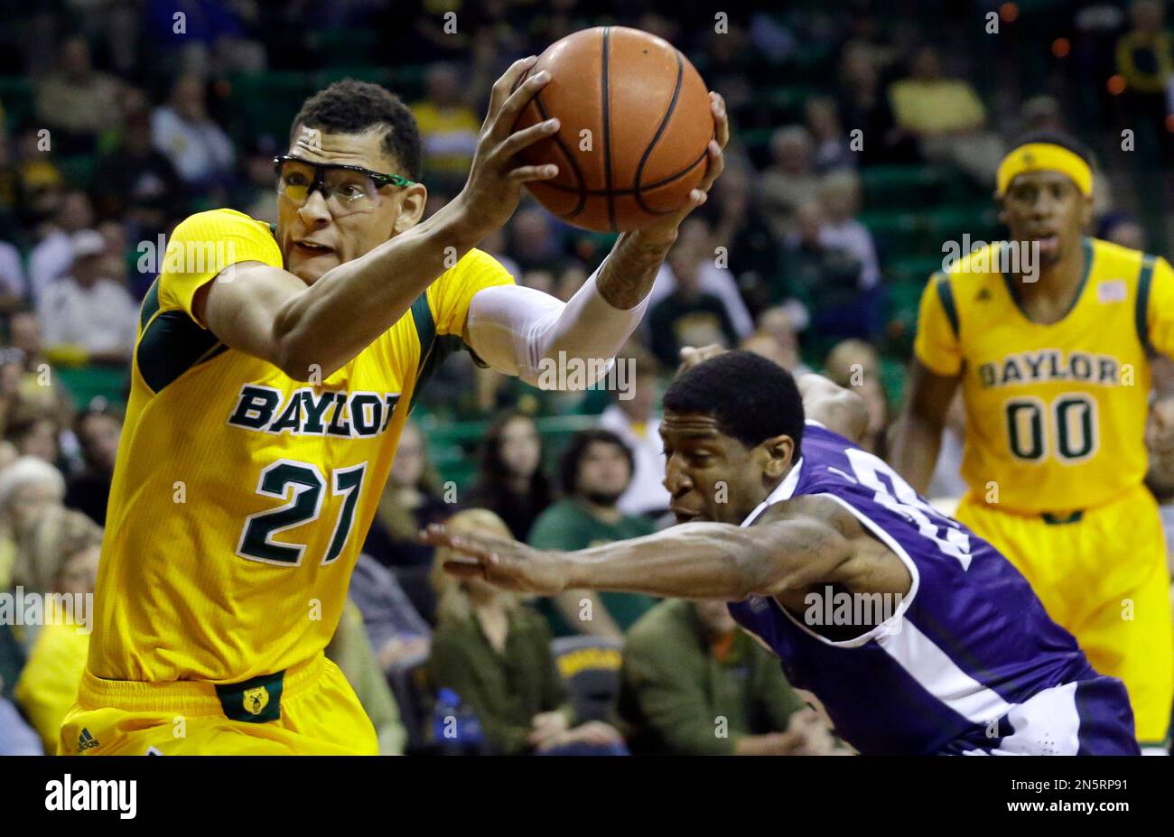 Baylor center Isaiah Austin (21) takes the ball past TCU guard Jarvis ...
