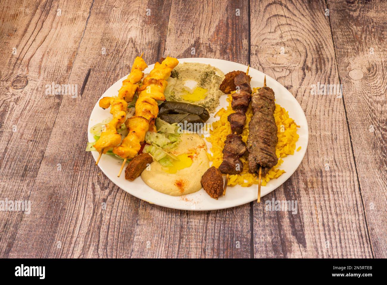 Menu kebab plate with Moorish chicken, lamb and beef skewers, hummus ...