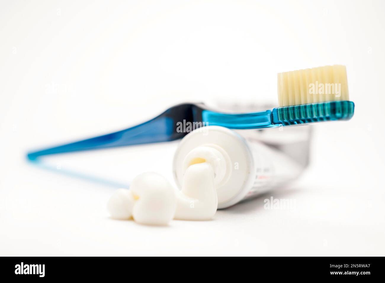 Toothpaste and toothbrush over a white background Stock Photo - Alamy